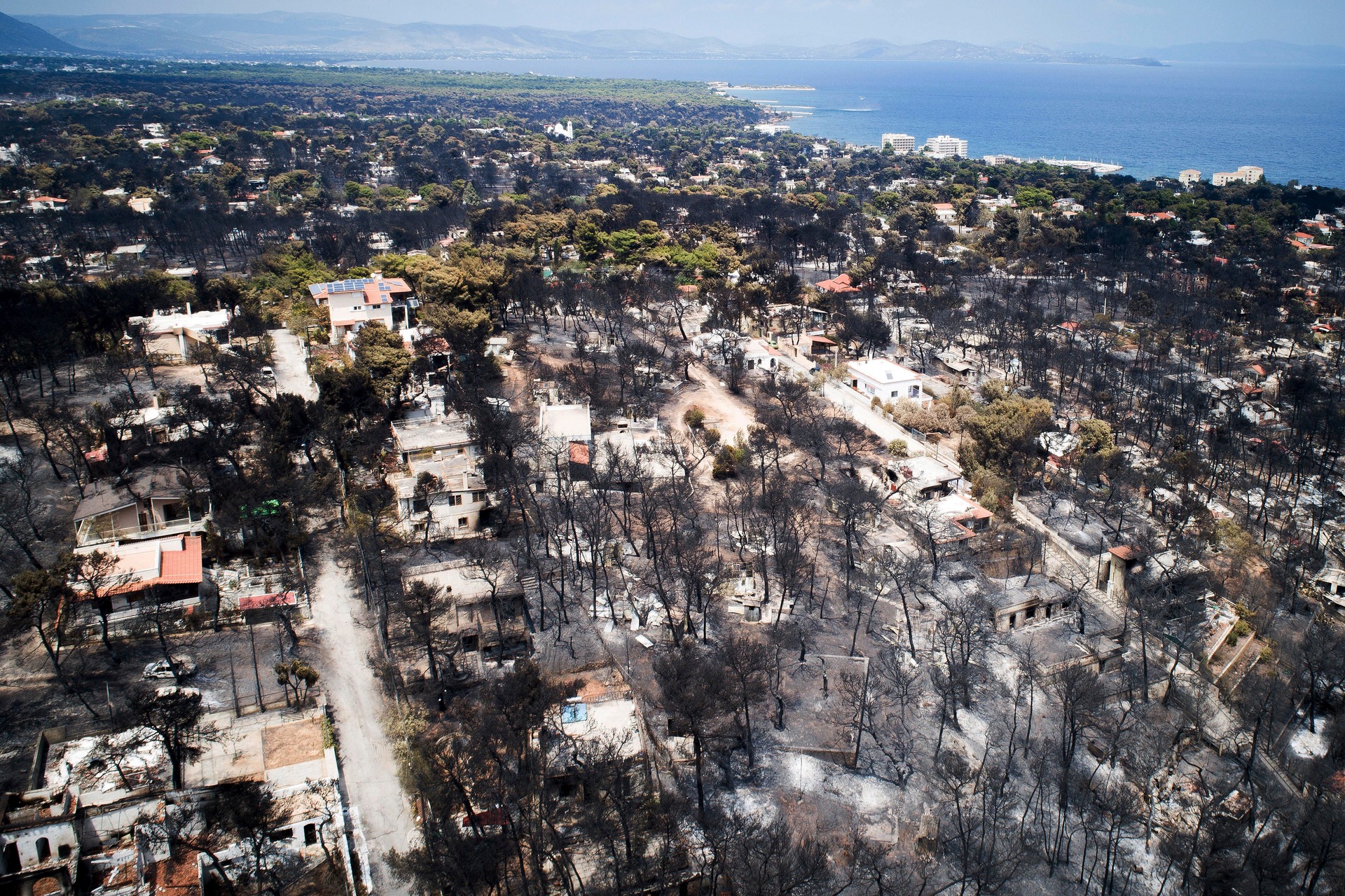 Terrifying footage of people huddling in the sea to escape Greece inferno